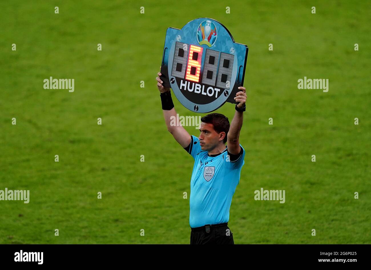 The fourth official holds up the electronic board to signal six minutes ...