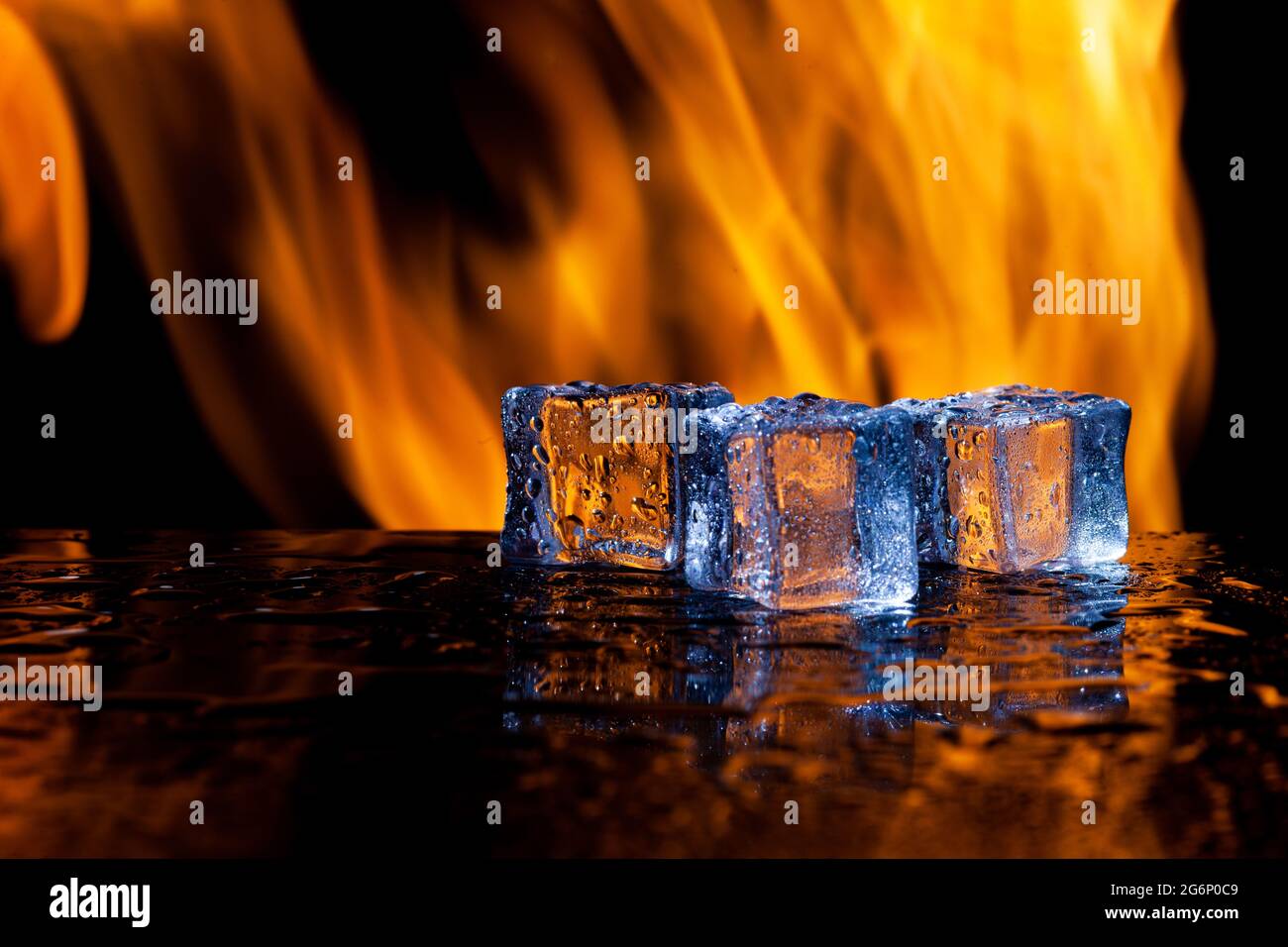three ice cubes against the background of fire, concept Stock Photo - Alamy