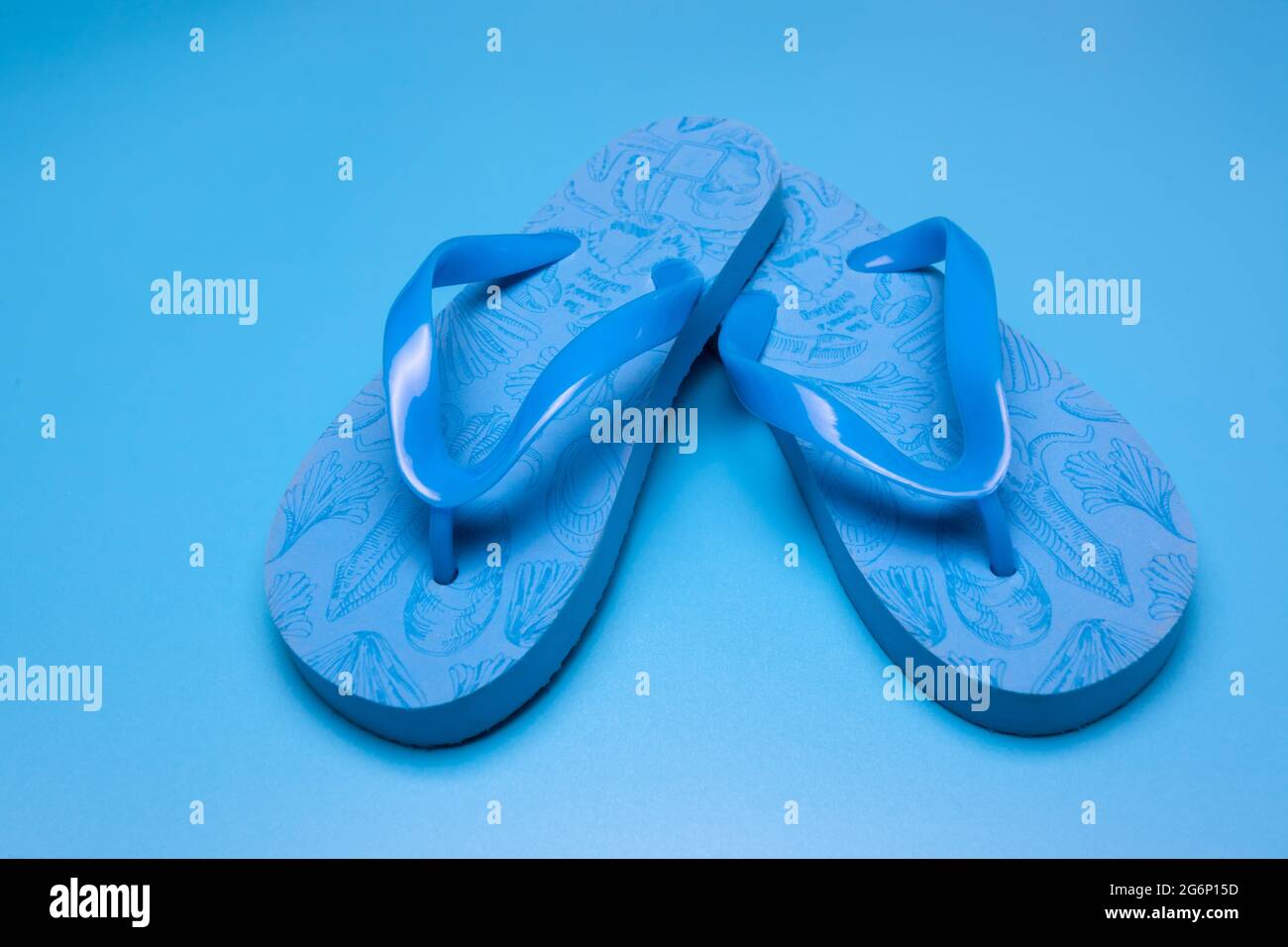 Blue flip flops on a blue background Stock Photo - Alamy