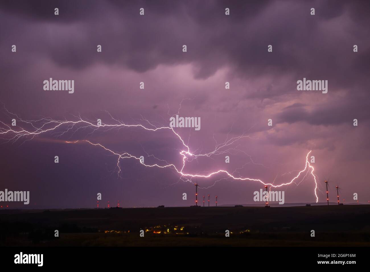 Lightning strike at a wind turbine field during a nighttime ...