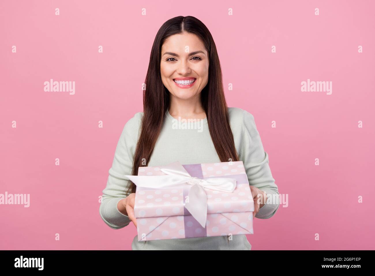 Photo of charming happy nice young woman give present you smile ...
