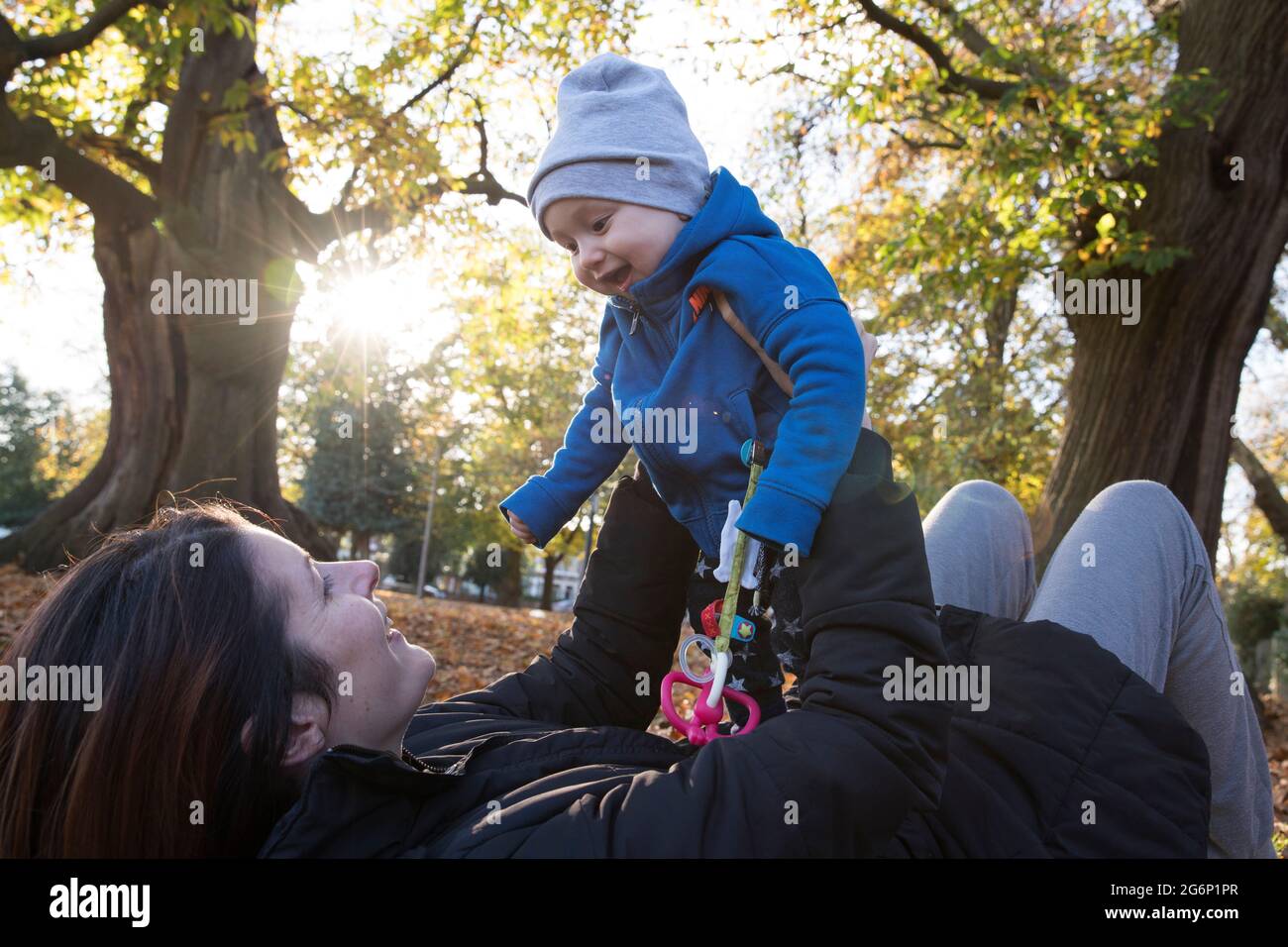 A mother with her baby in a park Stock Photo - Alamy