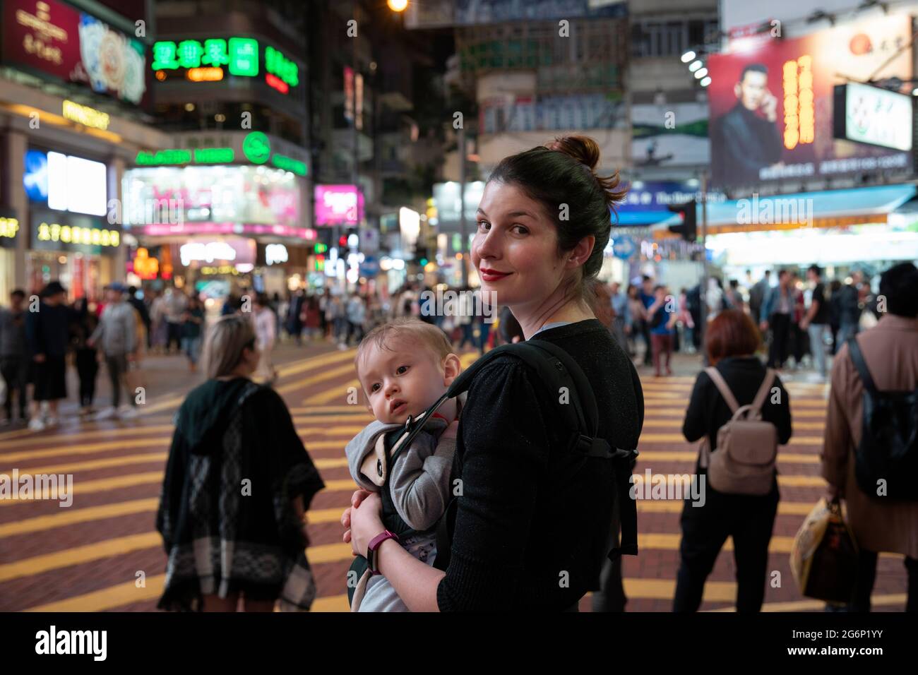 A mother and son walking through Times square in Hong Kong Stock Photo ...