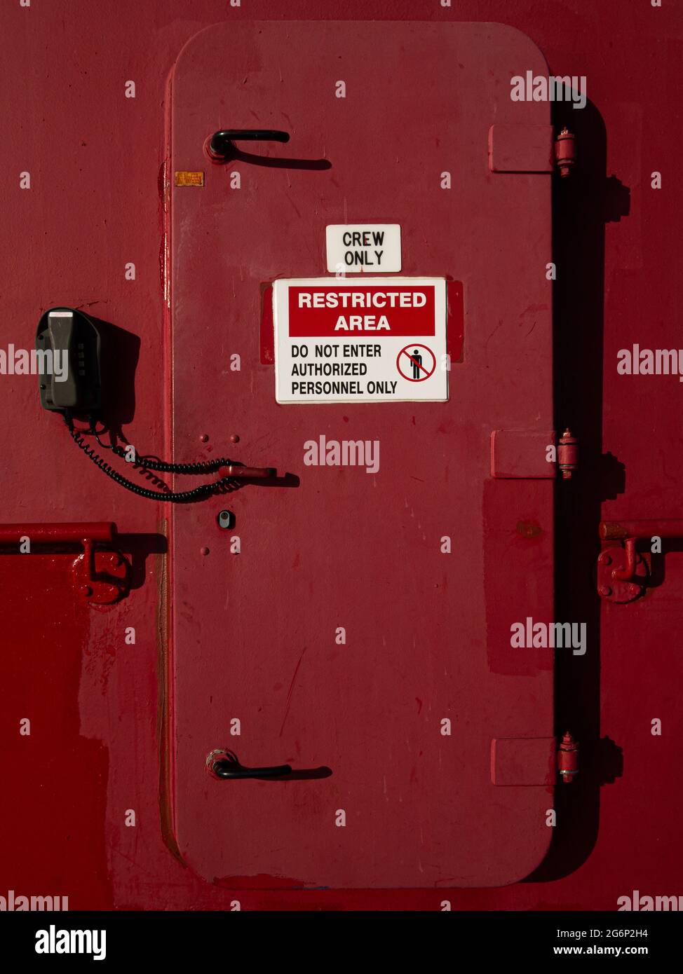 Restricted area red door. Do not enter. Authorized personnel only. Crew ...