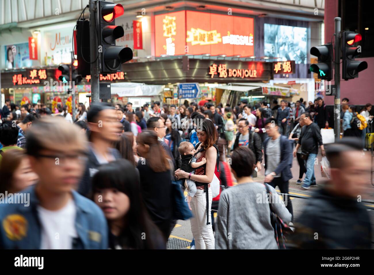 Mother carrying baby on crowd hi-res stock photography and images - Alamy