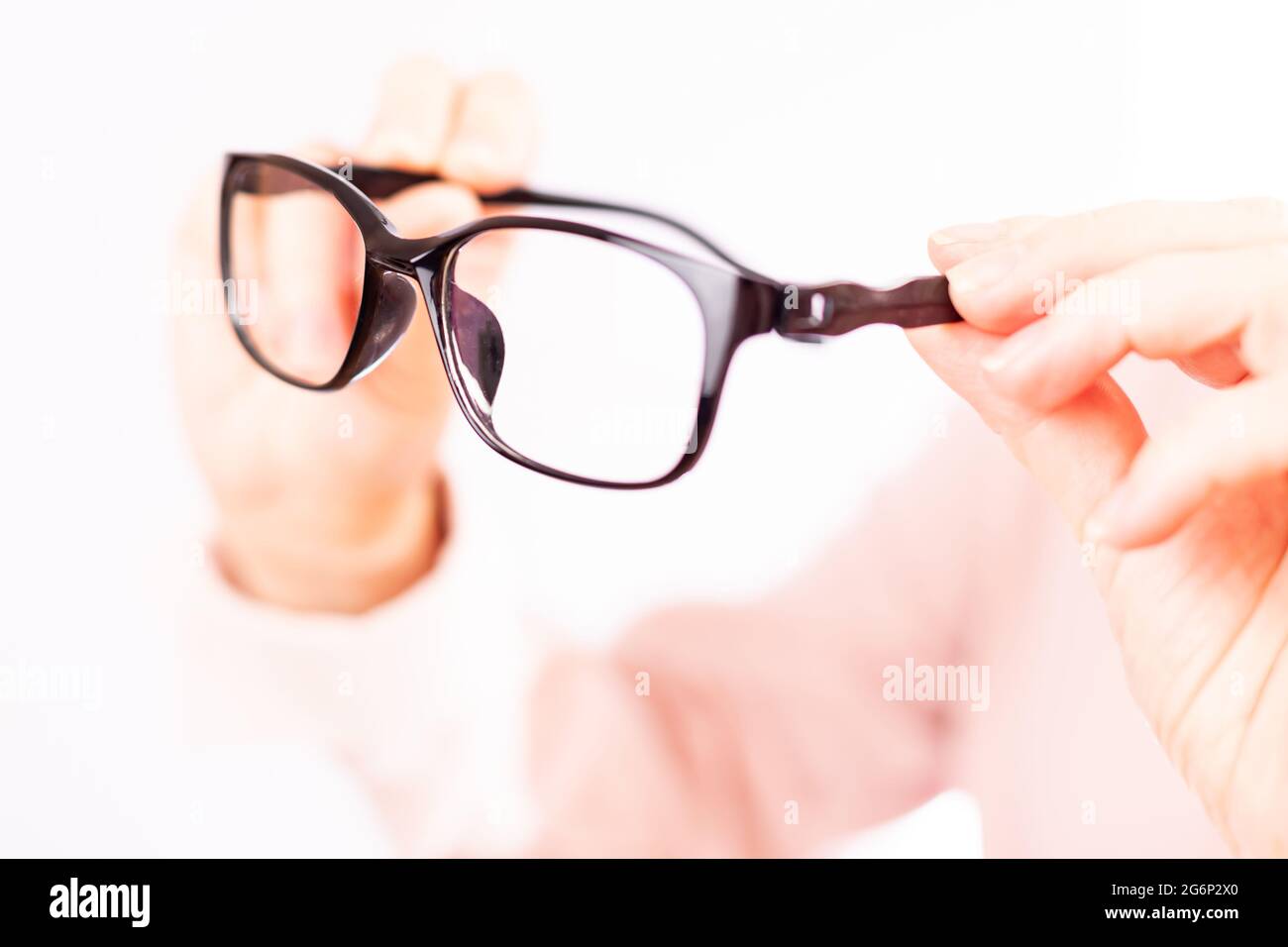 glasses in women's hands close-up, white background Stock Photo - Alamy