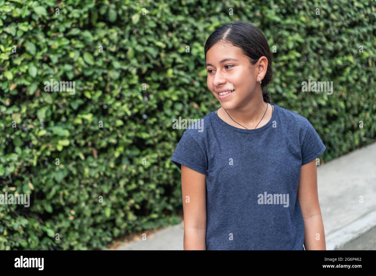 Teenager thinking and looking sideways in a park in the summertime ...