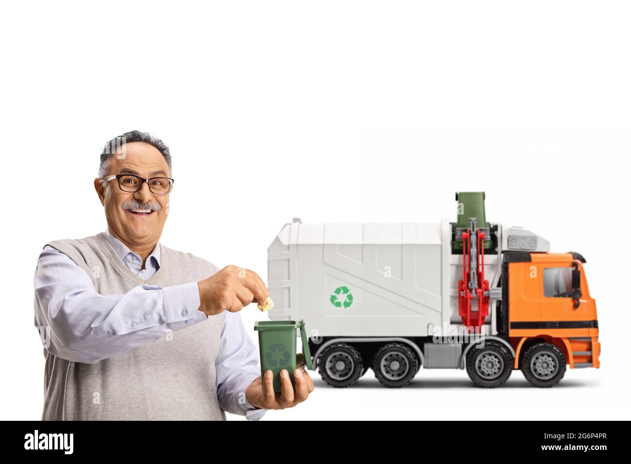 Mature man throwing paper in a small bin in front of a garbage truck ...