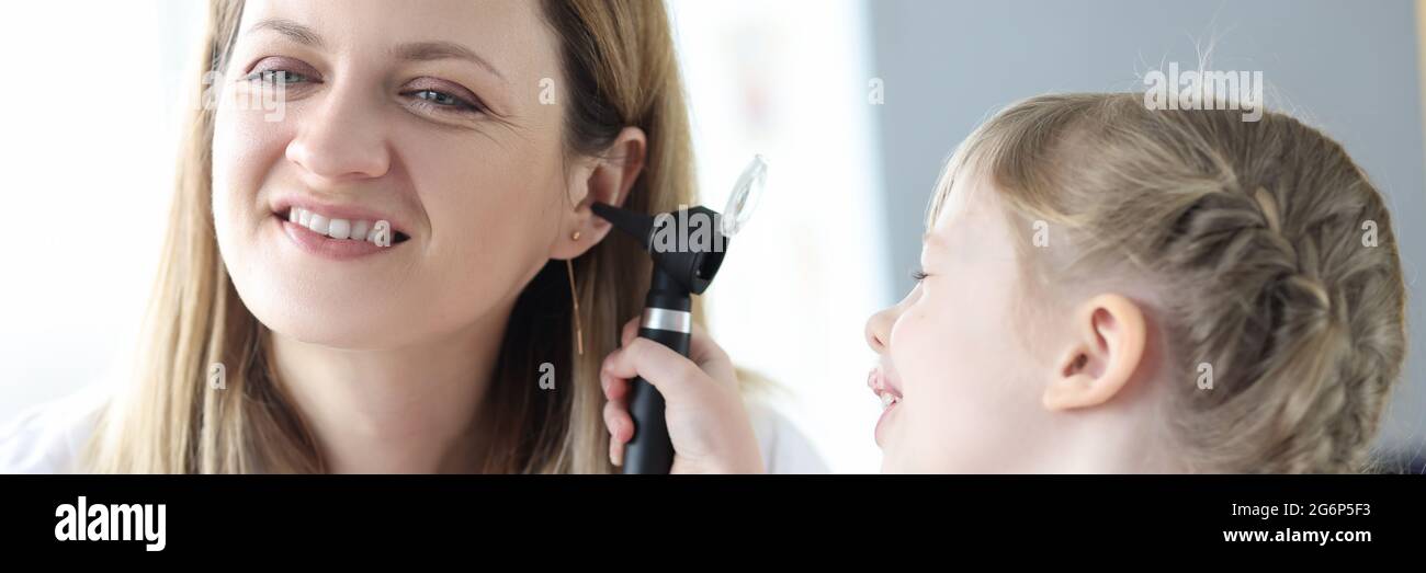 Little child examining doctor ear with otoscope in clinic Stock Photo ...