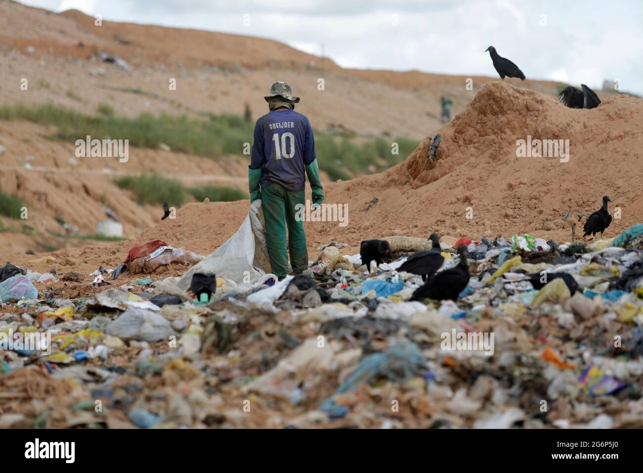 Poor man rummaging garbage in hi-res stock photography and images - Alamy