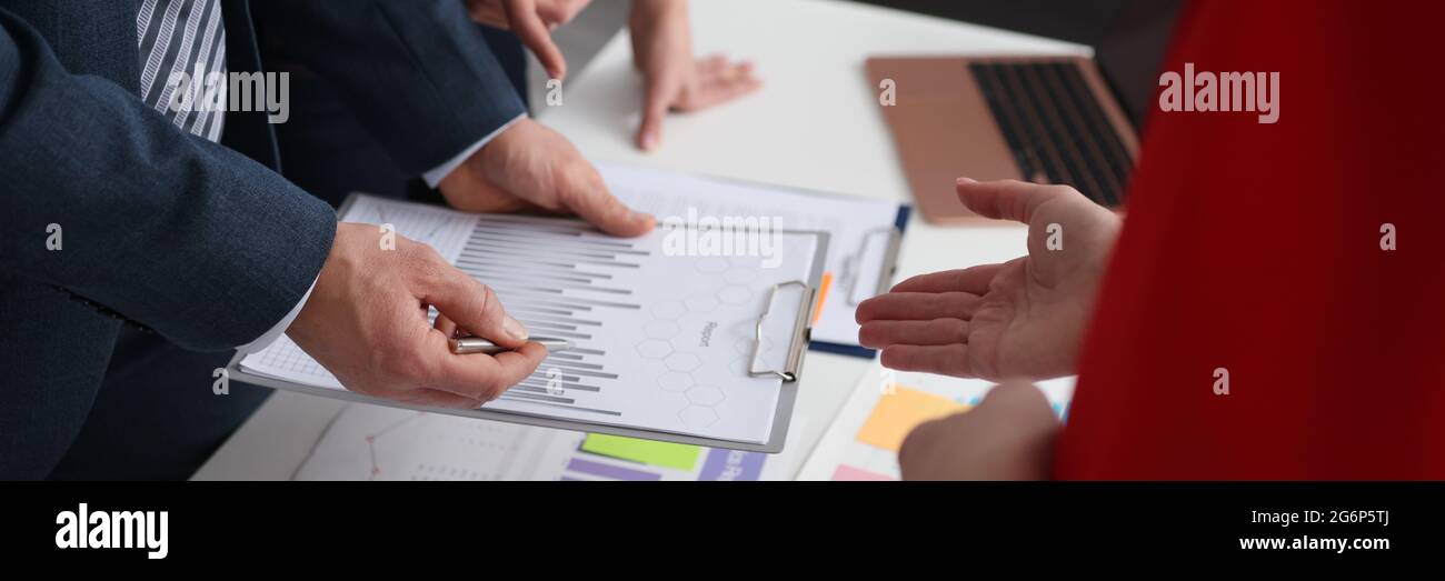 Group of people discussing chart in documents in office closeup Stock ...