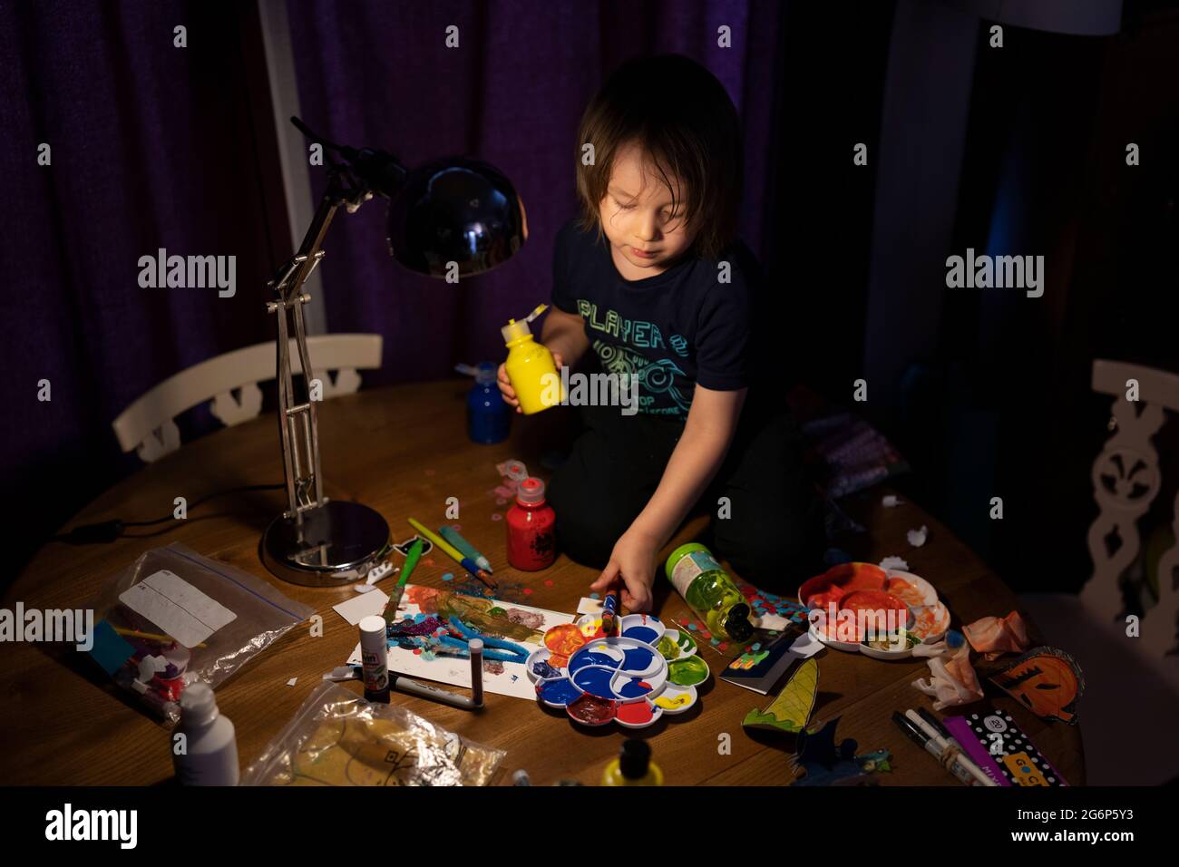 A young boy doing arts and crafts at home Stock Photo - Alamy