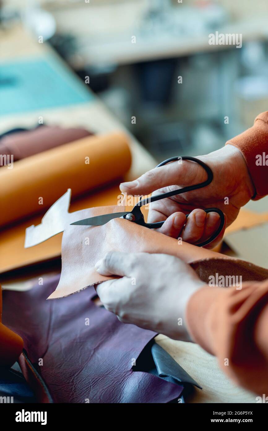 Craftsman cutting natural material use scissors. Working process at ...