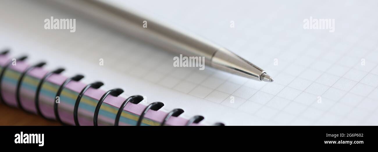 Metal ballpoint pen lying on notepad closeup Stock Photo - Alamy