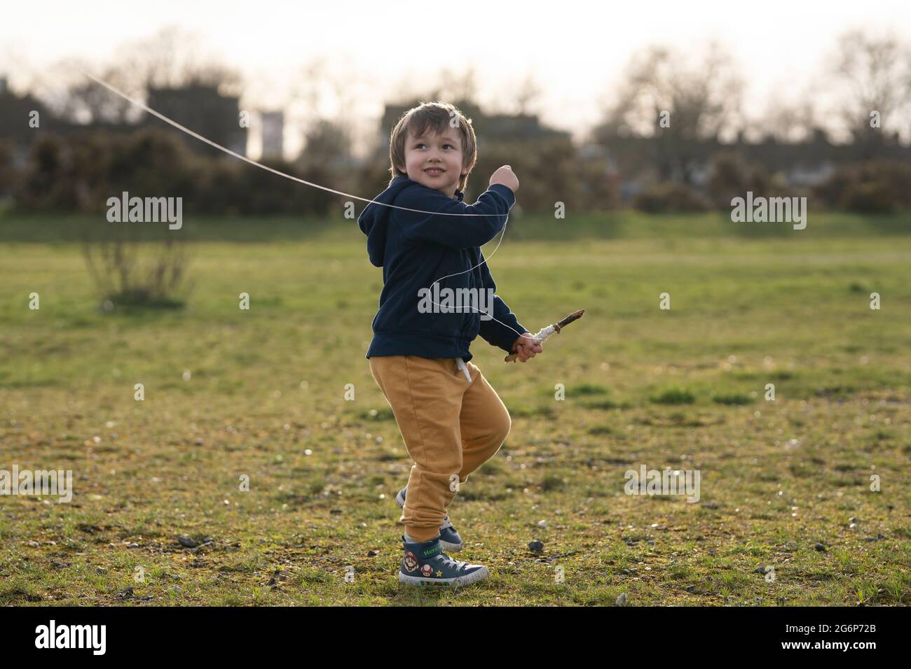 A young boy flying a kite in London Stock Photo - Alamy