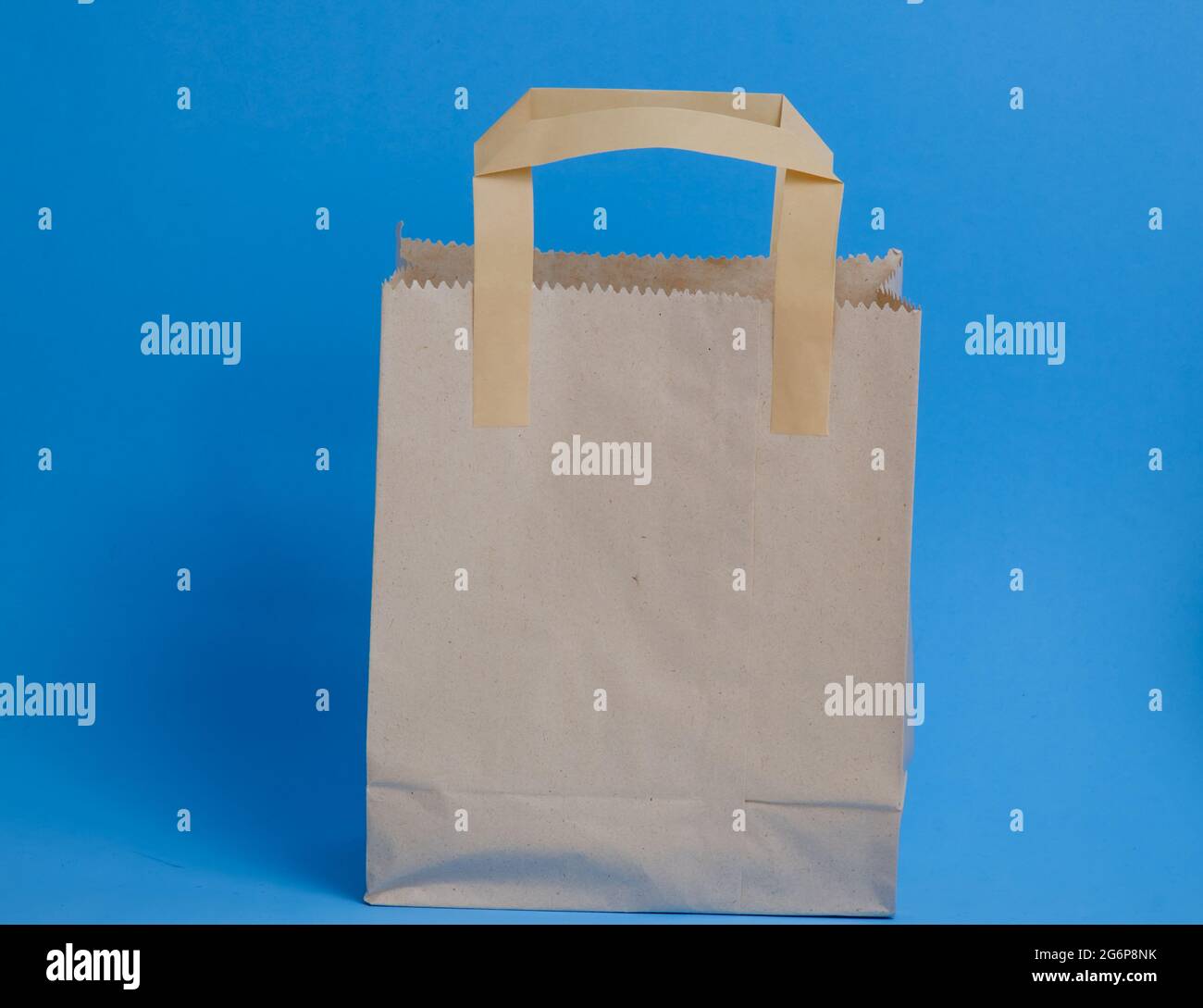 brown paper shopping bag on blue background. Brown empty craft lunch ...