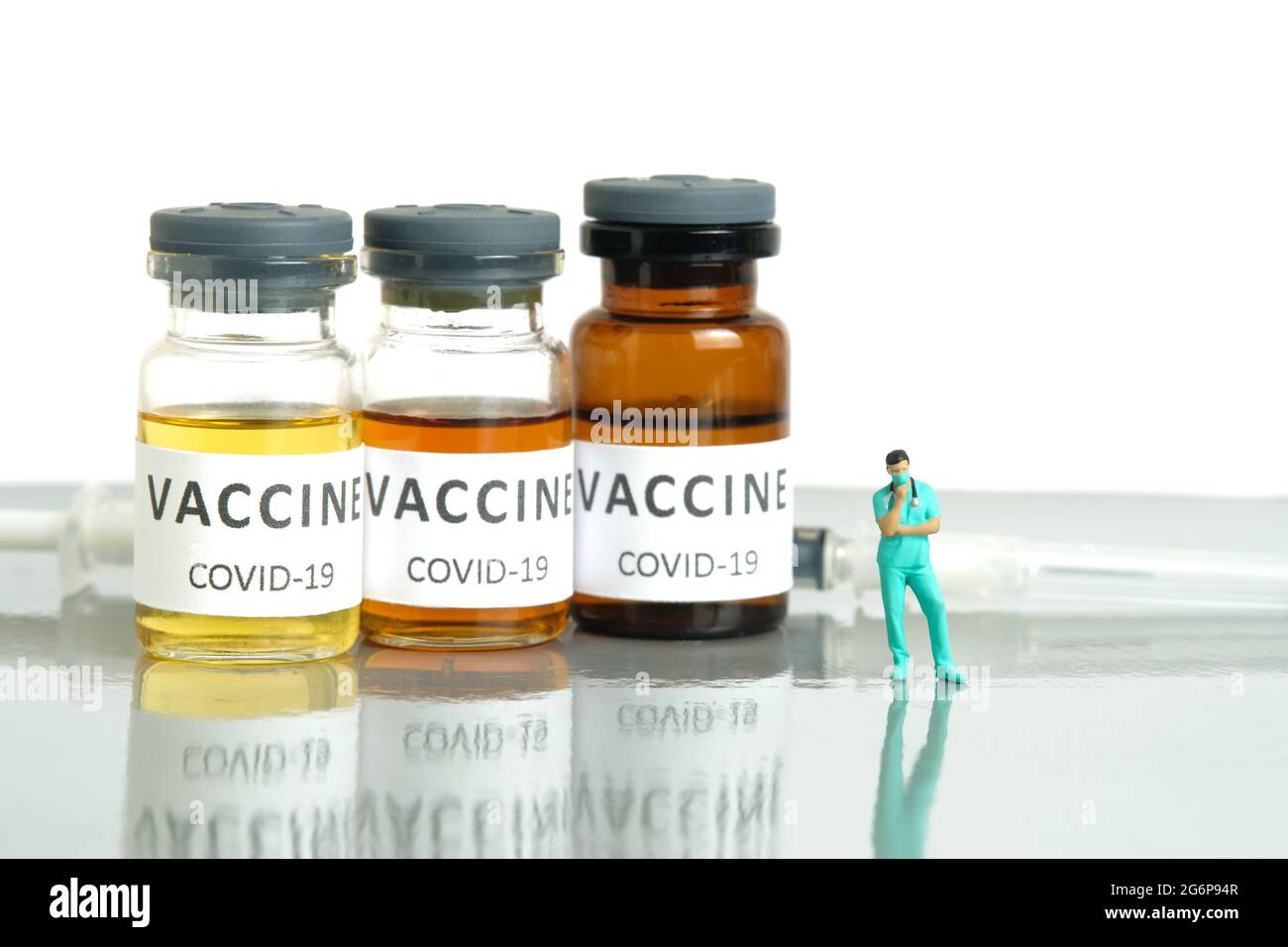 Miniature people toy figure photography. Vaccine injection concept. A ...