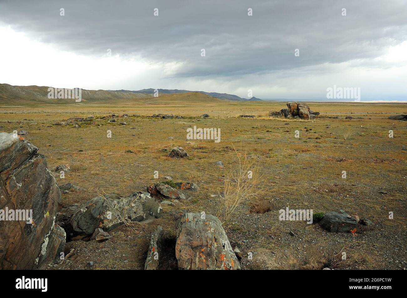 Ruins of an ancient stone structure in the autumn steppe under storm ...