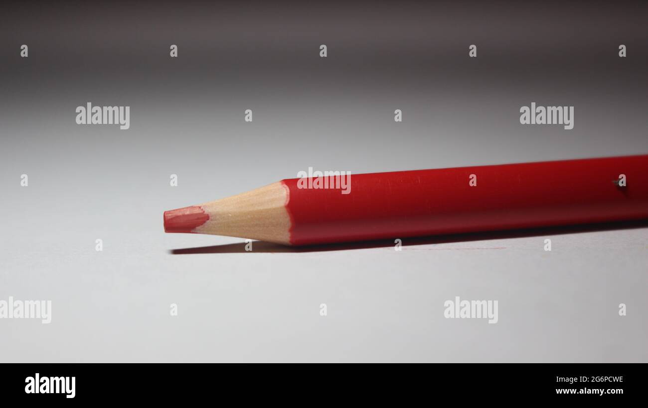 Close up shot of isolated red color pencil on white color background ...