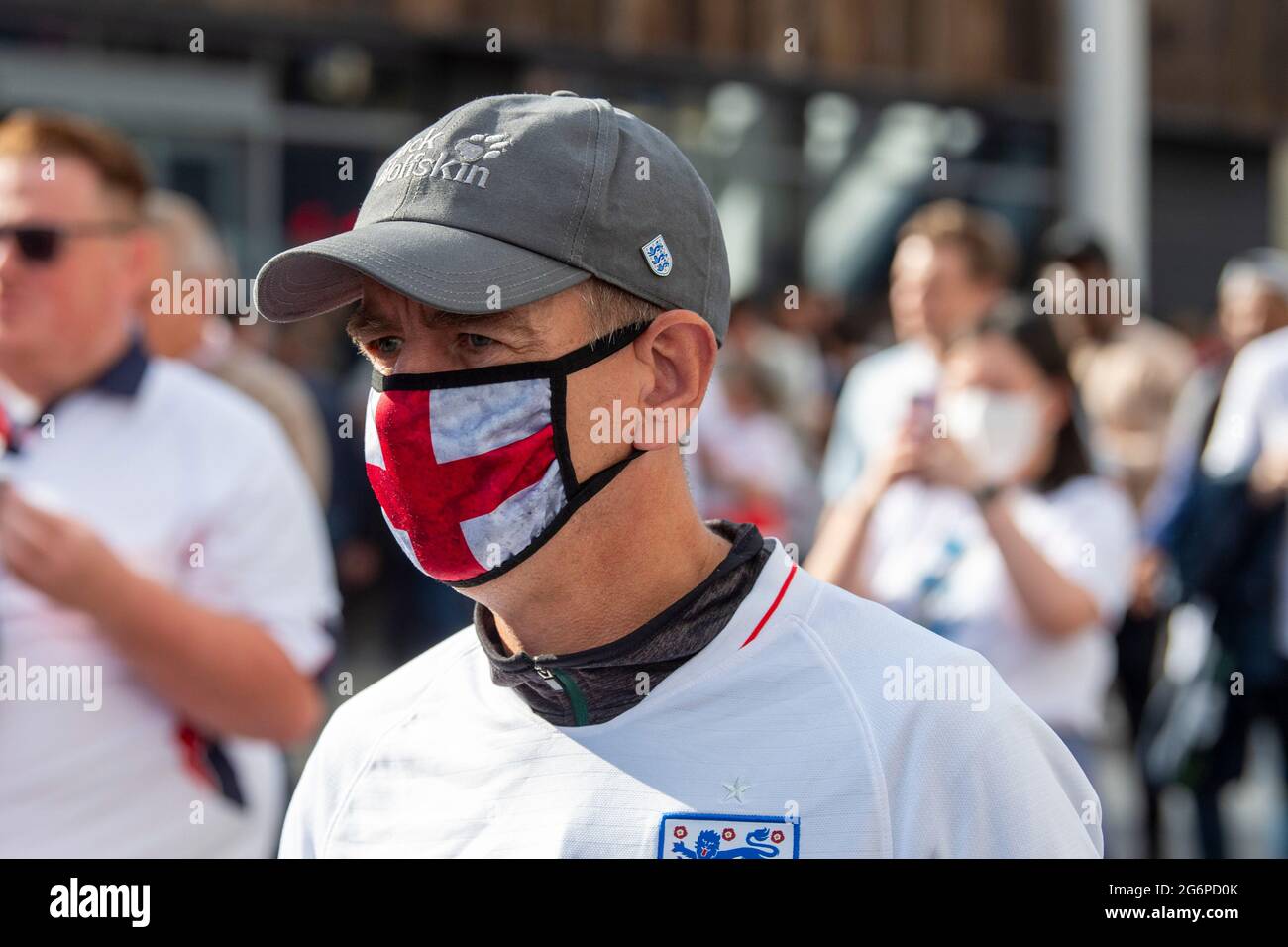 London, UK. 07th July, 2021. An England fan wears a St George cross ...