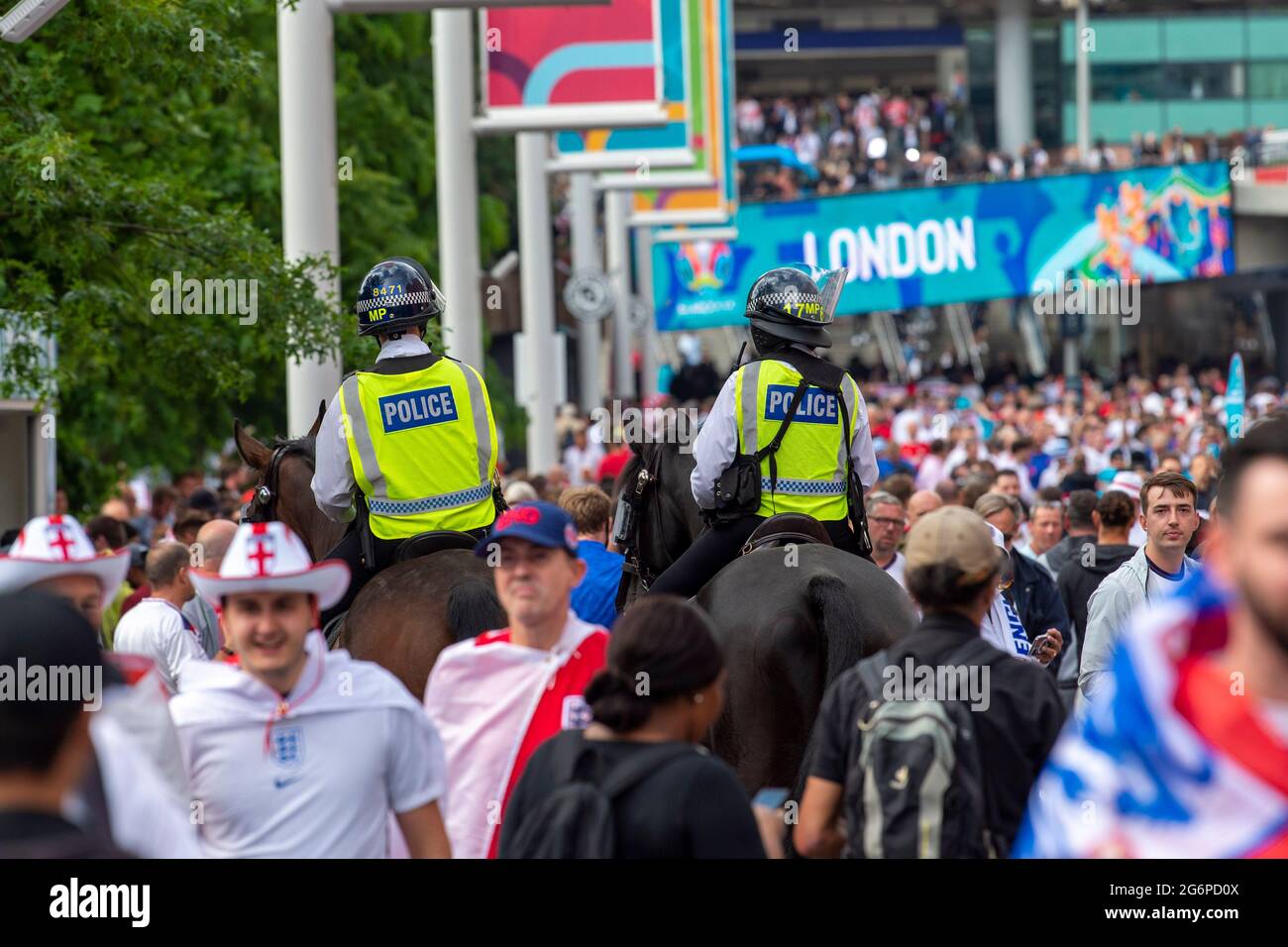 London, UK. 07th July, 2021. Mounted Police watch fans as they arrive ...