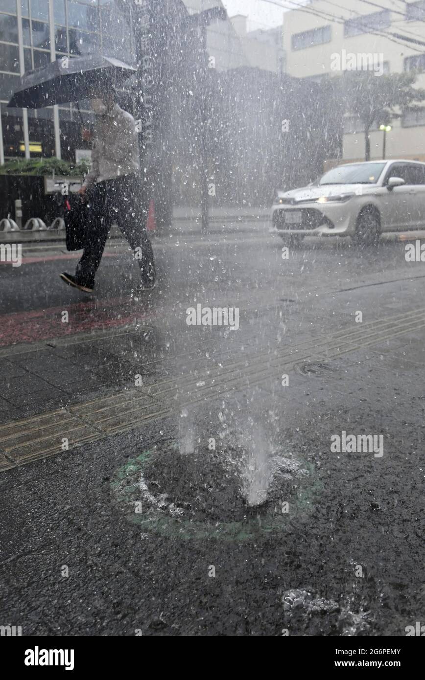 Water spurts out of a manhole in Hiroshima, western Japan, on July 8 ...