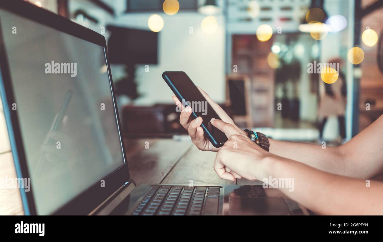 Woman use technology devices smartphone and laptop to work or study do ...