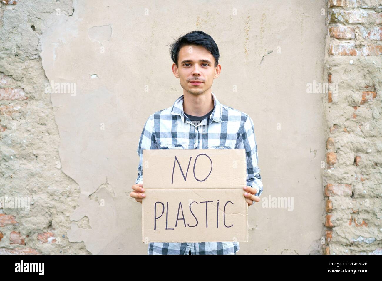 Young man with the inscription on the cardboard no plastic. Caucasian ...