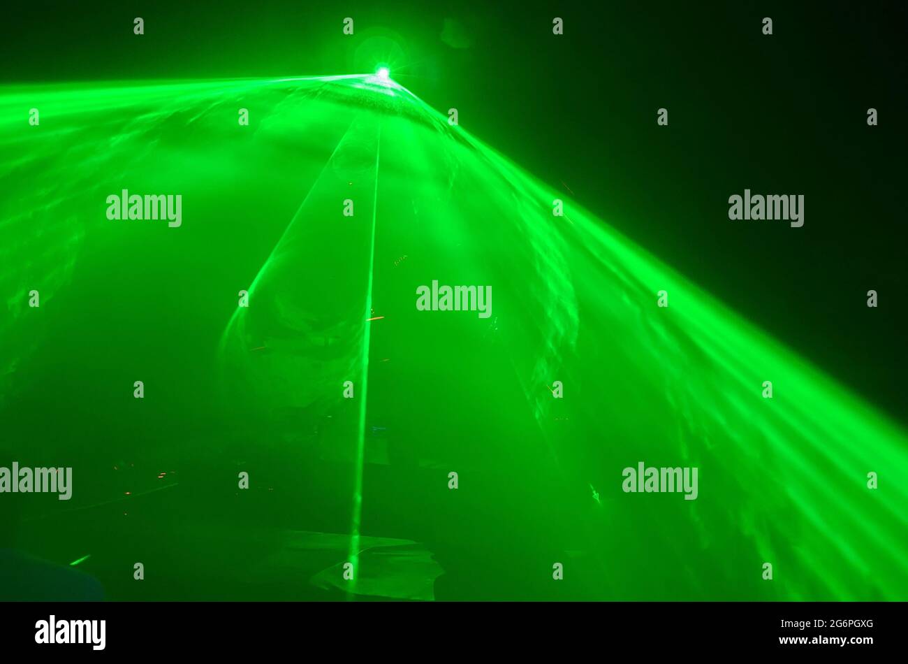 Disco laser show, green laser in smoke on a black background Stock ...