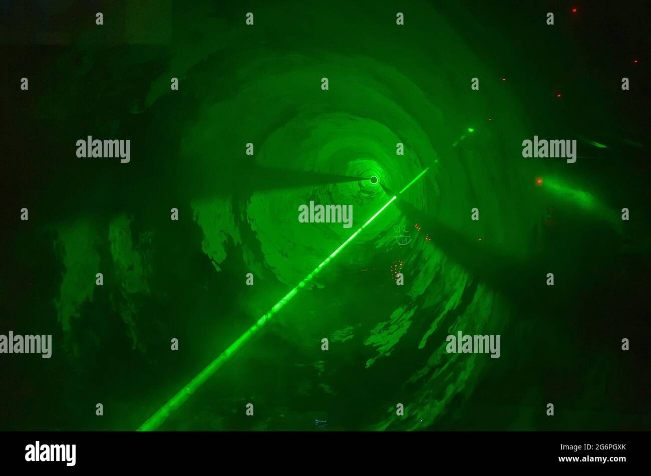 Disco laser show, green laser in smoke on a black background Stock ...