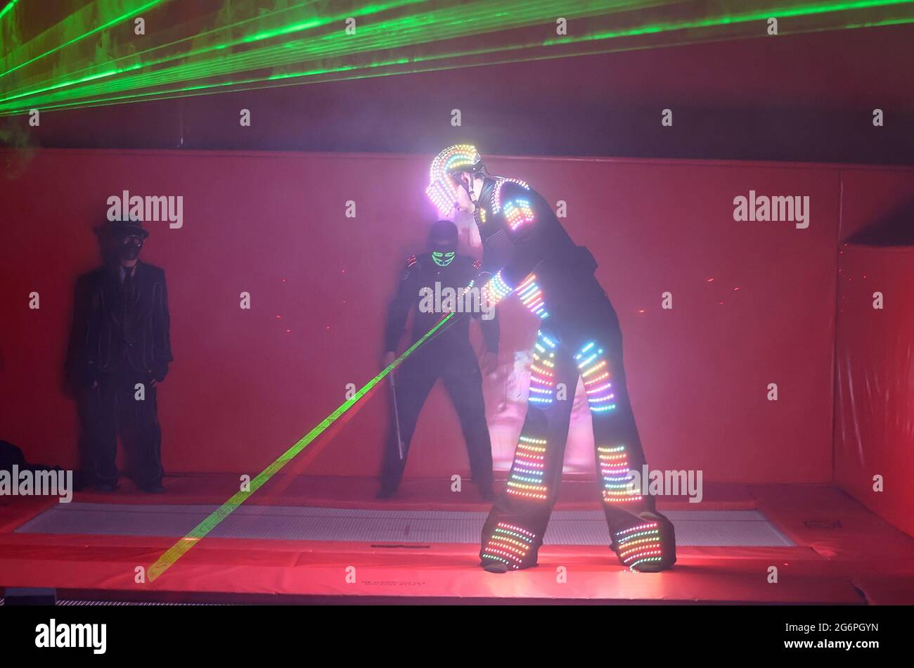 One dancer in a colored LED suit dances with a laser in his hands Stock ...