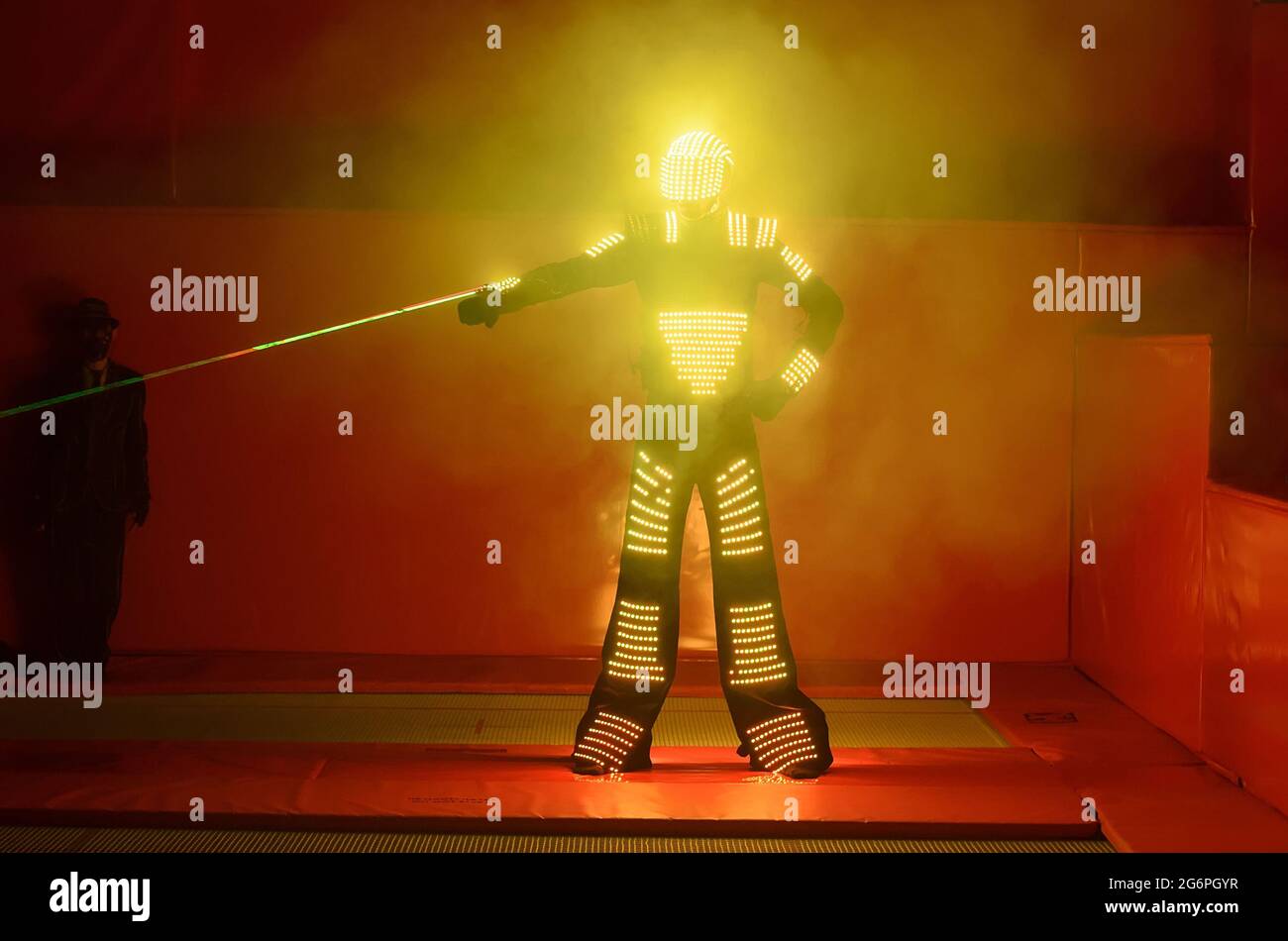 One dancer in a red LED suit is dancing with a laser in his hands Stock ...