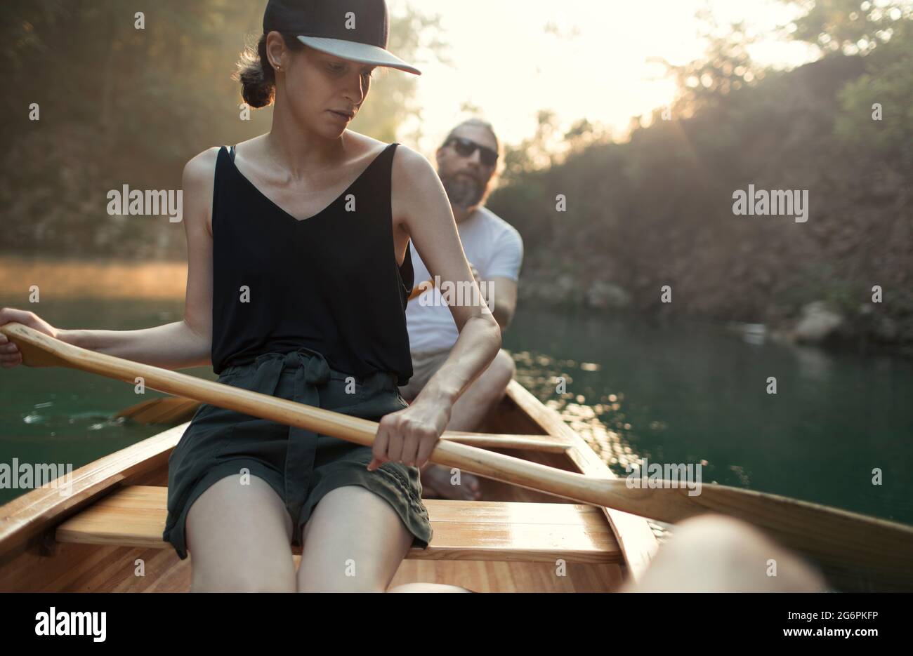 Woman and man paddling canoe Stock Photo - Alamy