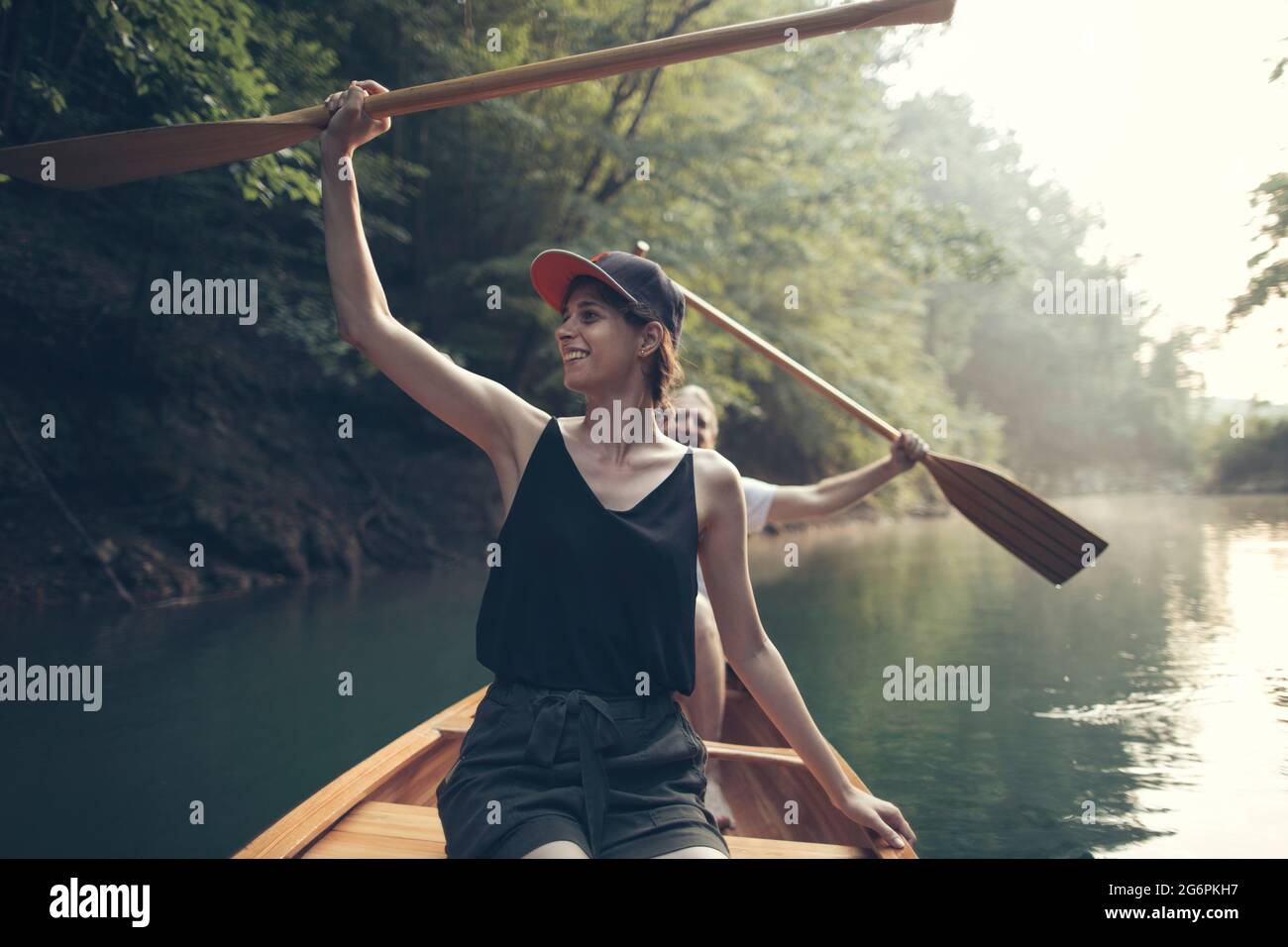Couple enjoy canoeing on a forest lake Stock Photo - Alamy