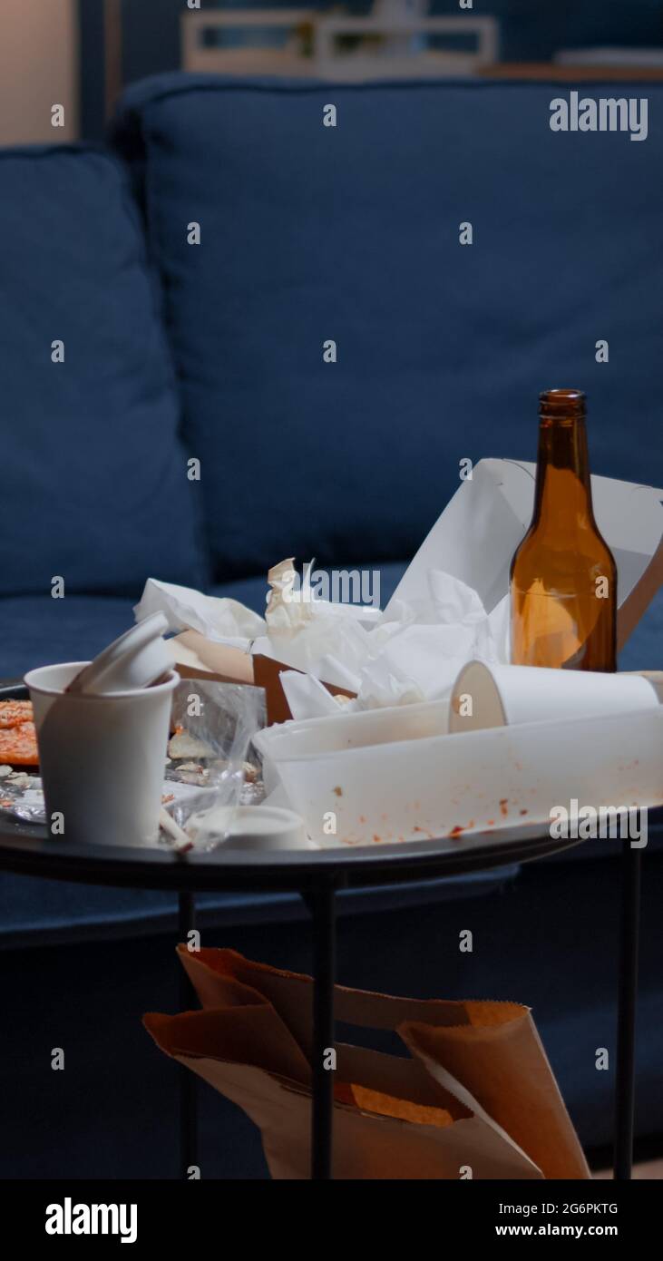 Empty home of depressed person with messy table with leftover thrown on ...