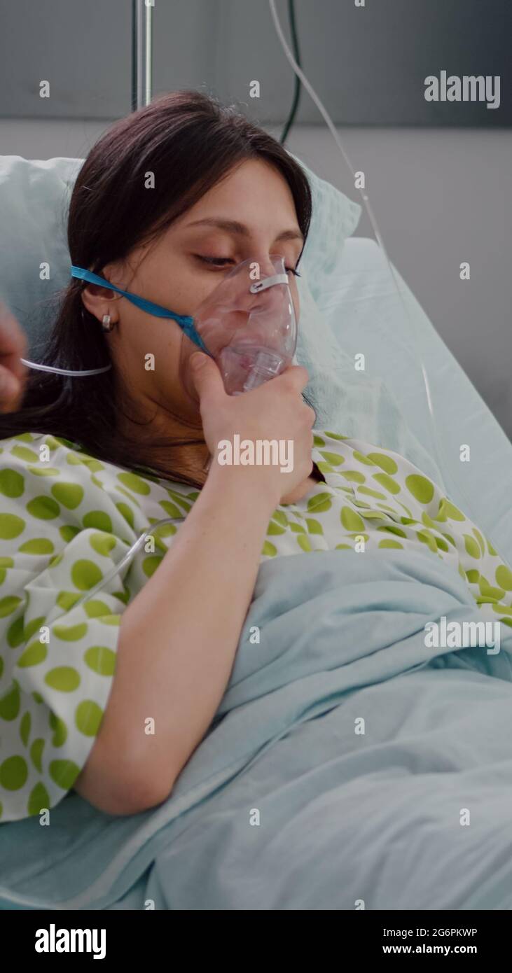 Patient resting in bed having respiratory illness while doctors ...