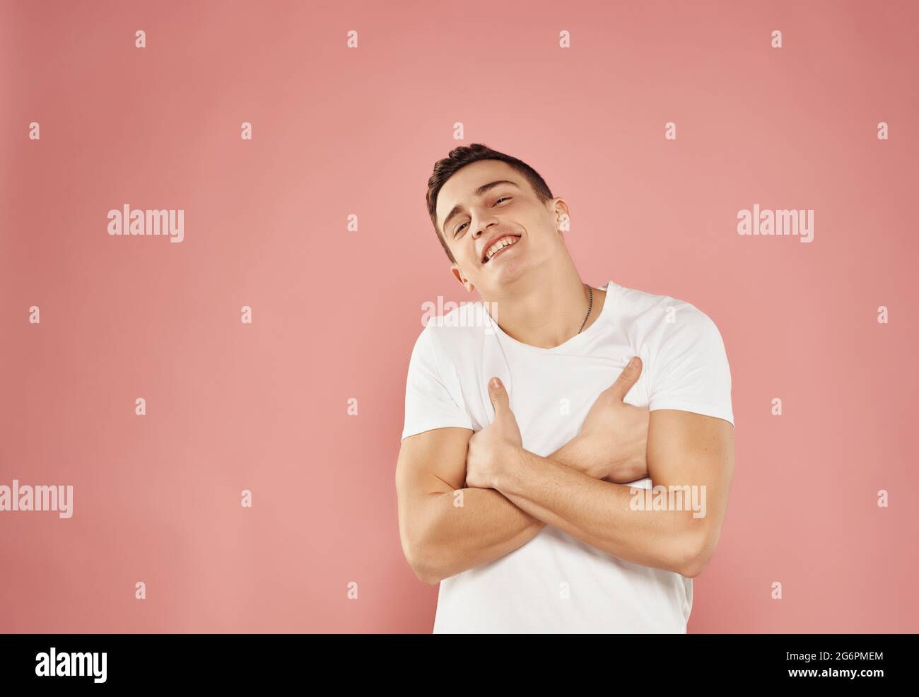 handsome man fun gesture with hands pink background emotions Stock ...