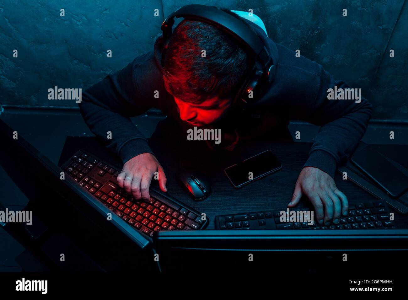 Hacker programmer using computer in dark room Stock Photo - Alamy