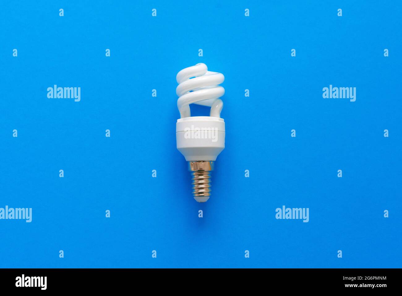 One light bulb on a blue paper background Stock Photo - Alamy
