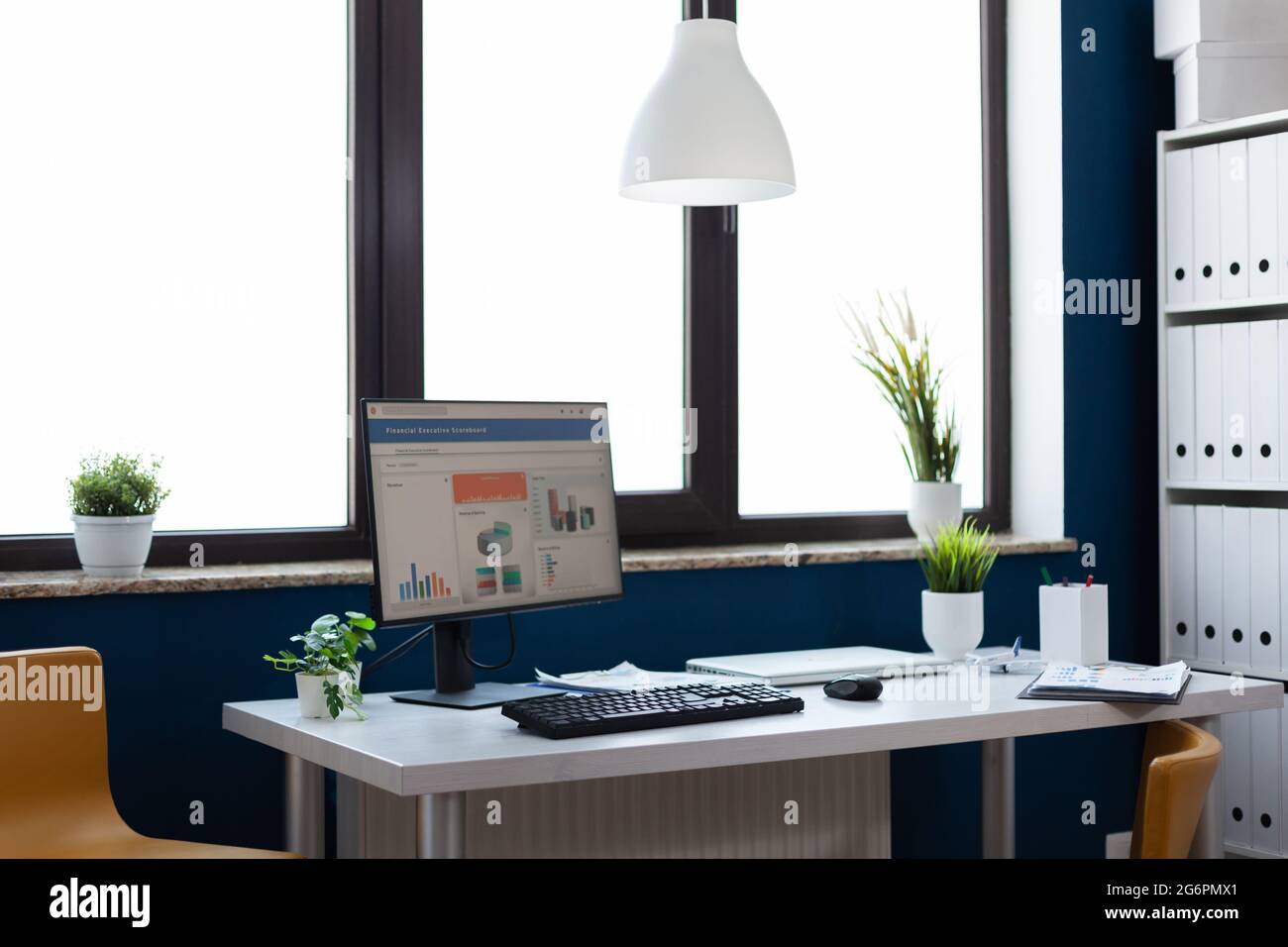 Flowers surrounding computer with financial statistics and charts in ...