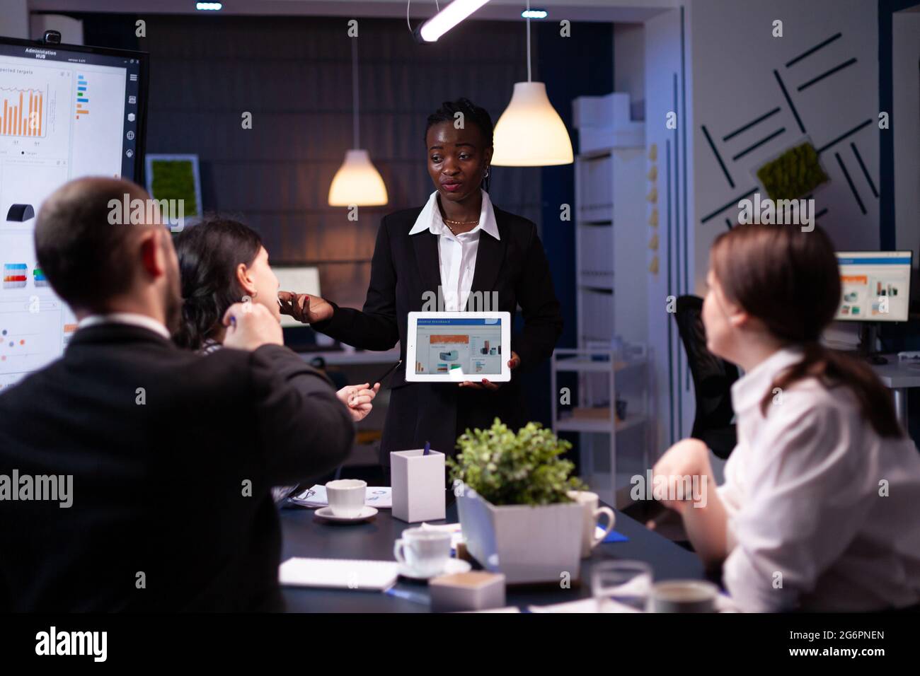 Exhausted workaholic african american showing financial graphs using ...