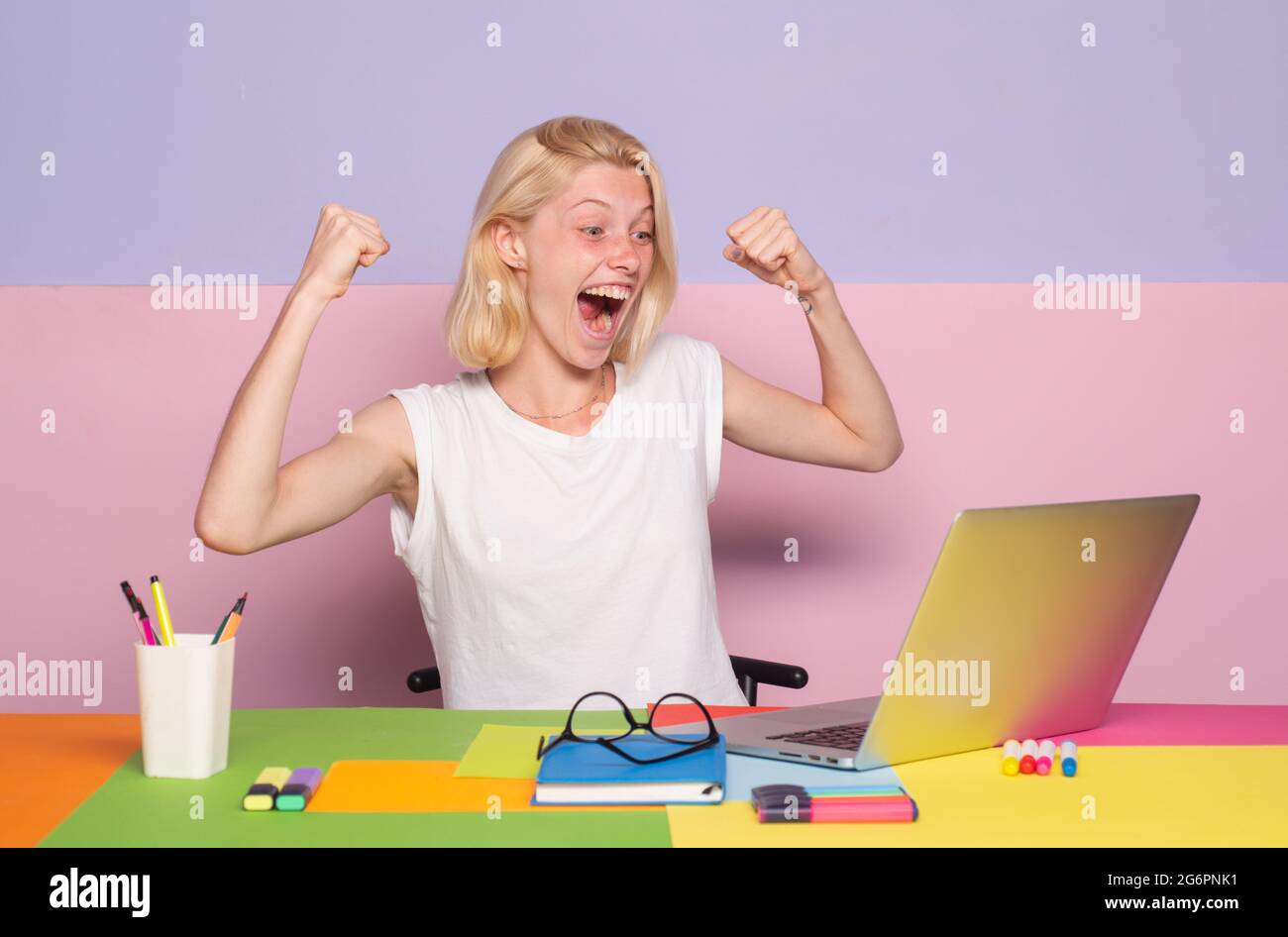 Excited amazed teacher works on laptop. Shcool teacher in class ...