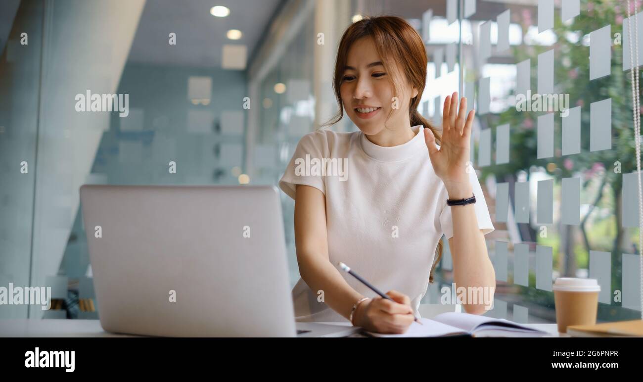 Young female college taking notes and using highlighter. Focused ...