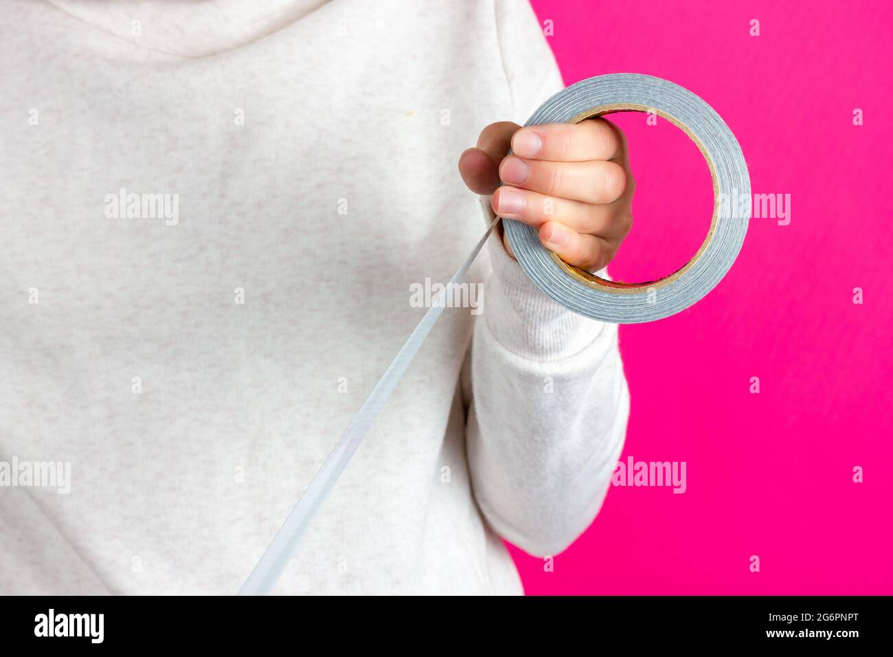 Adhesive tape in female hands. The process of tearing off the adhesive ...