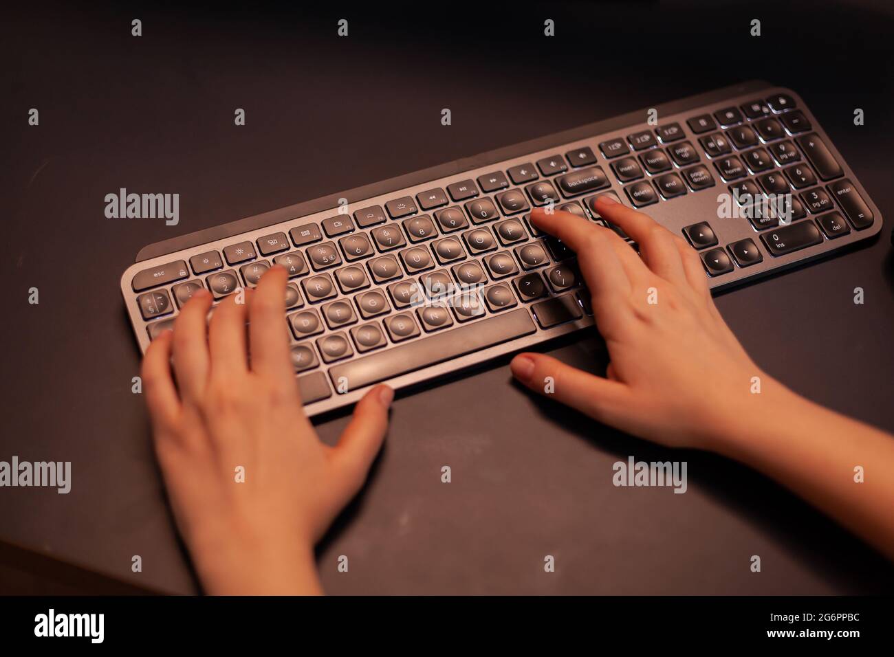 Close up hands shot of gamer pushing the keyboard buttons while playing ...