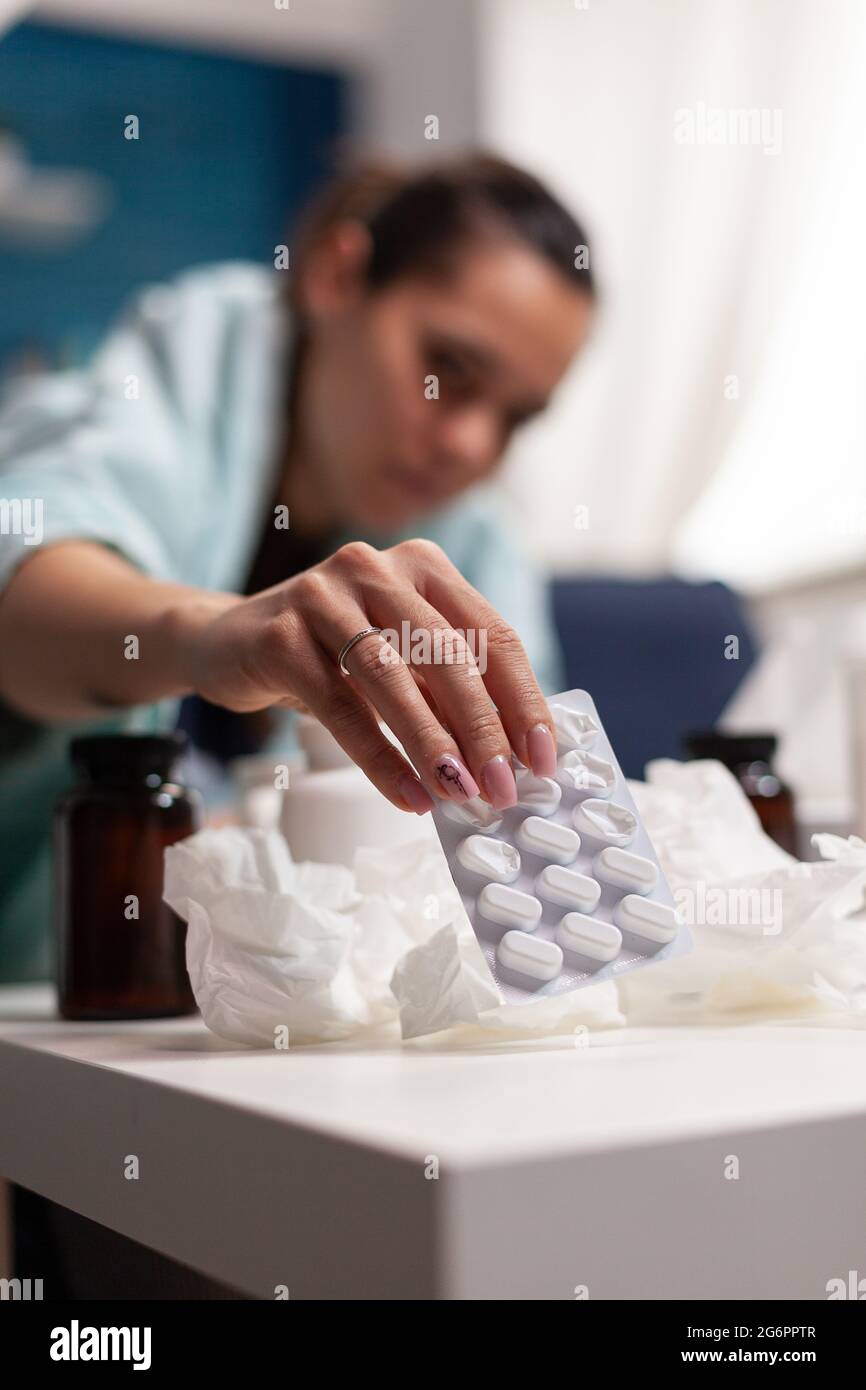 Woman sick in bed having tablets hi-res stock photography and images ...