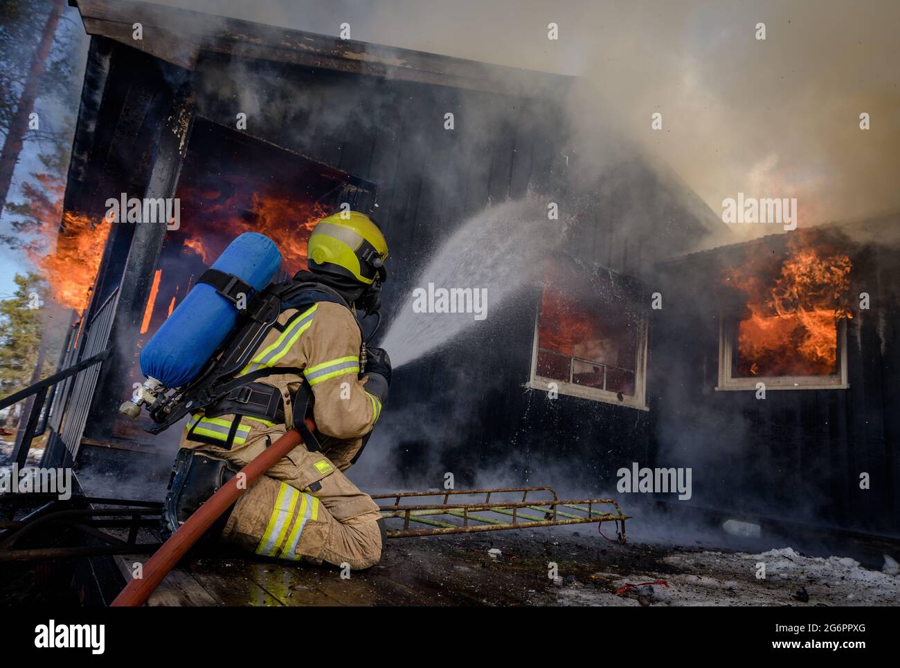 Firefighters trying to put out flames cabin on fire Stock Photo - Alamy