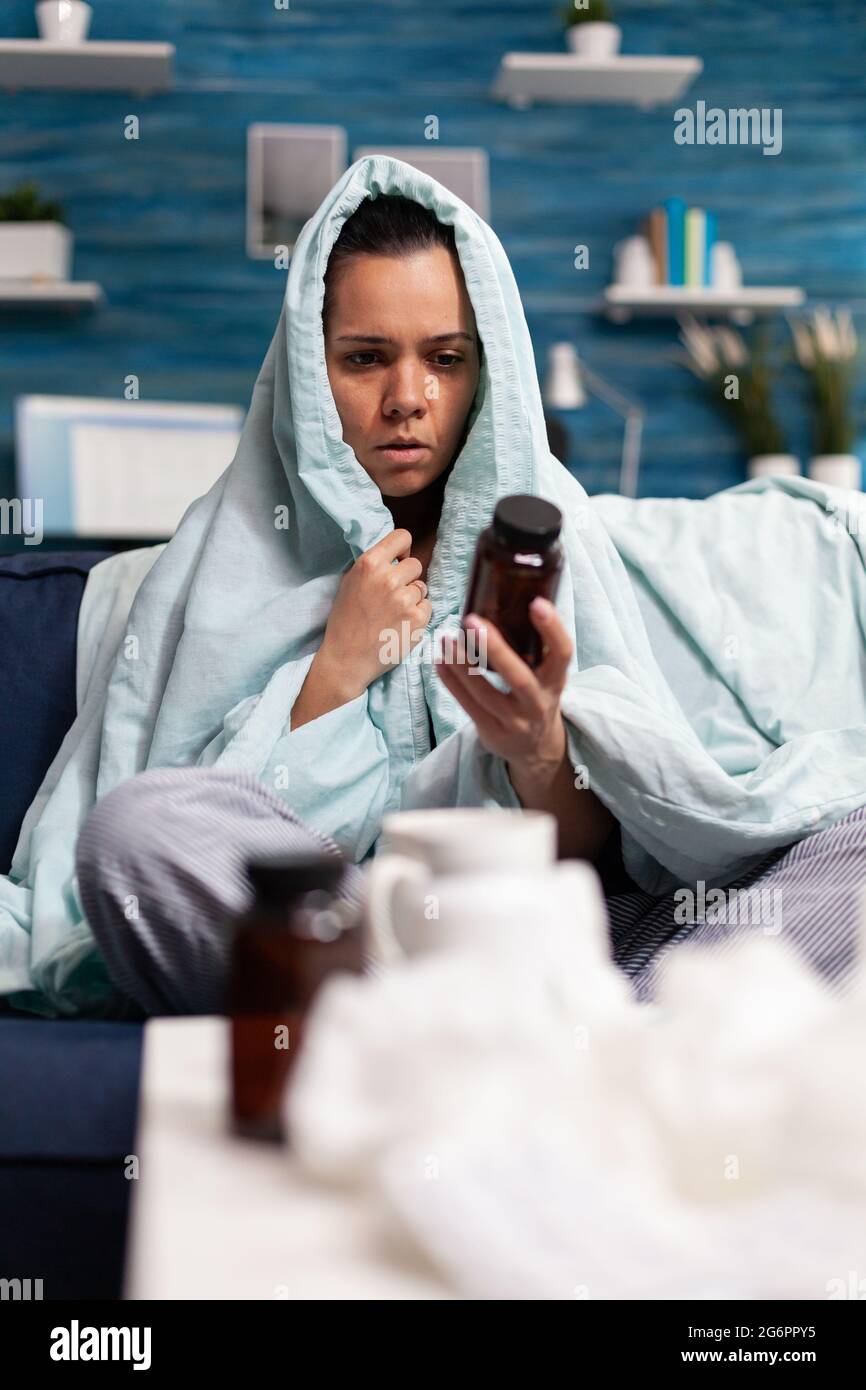 Sick woman taking medical treatment pills drugs antibiotics for illness ...