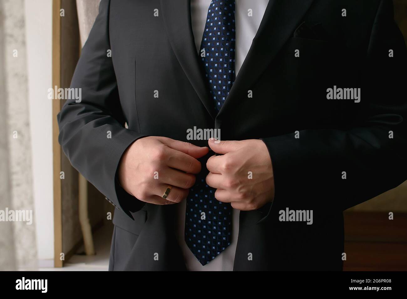 Businessman man fastens jacket hi-res stock photography and images - Alamy