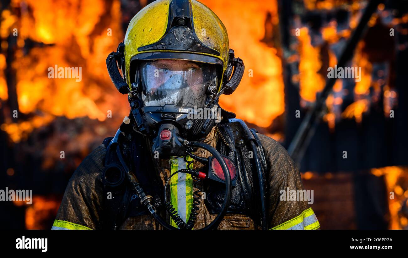 Firefighters trying to put out flames cabin on fire Stock Photo - Alamy